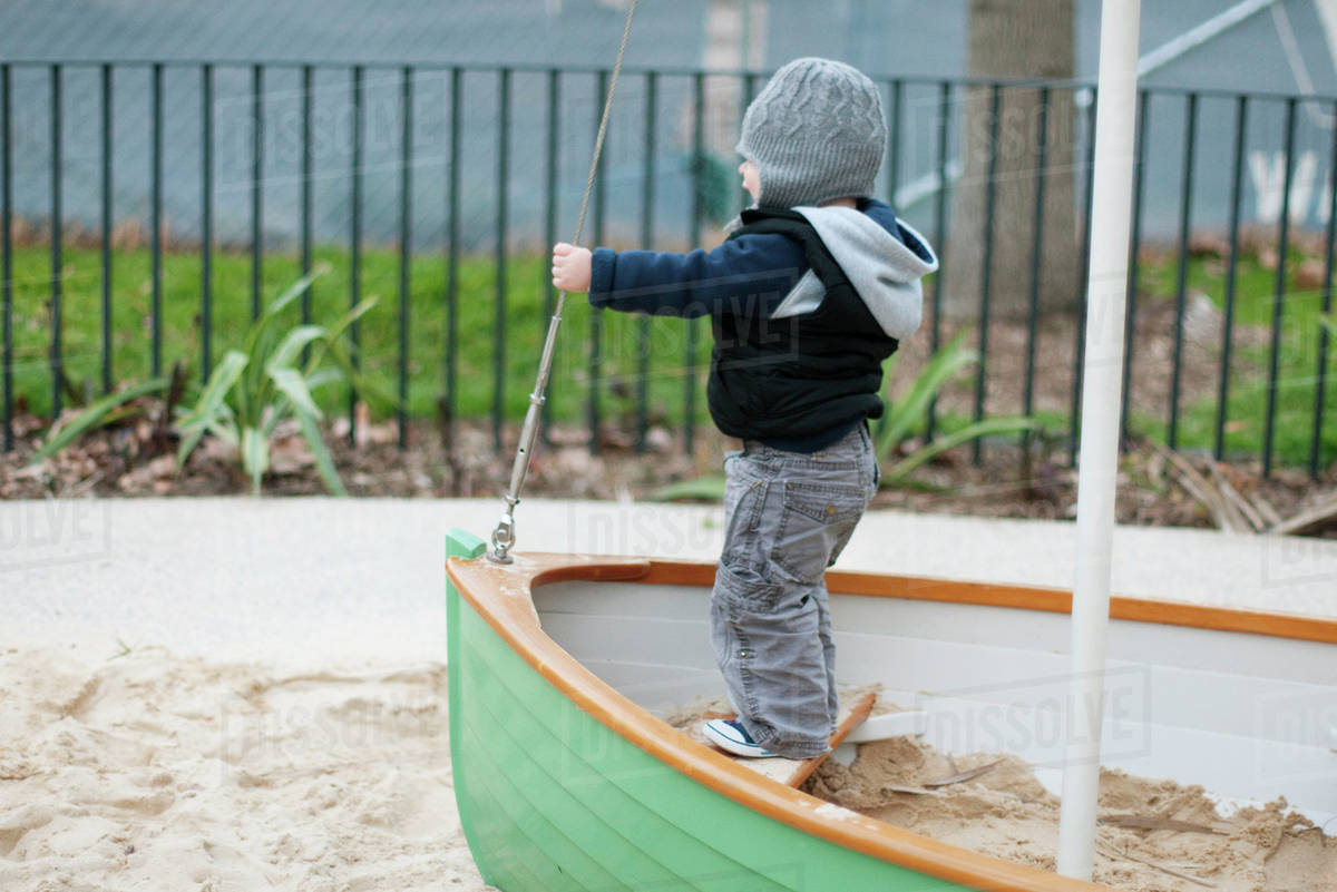 Toddler playing on boat - Royalty-free Stock Photo | Dissolve