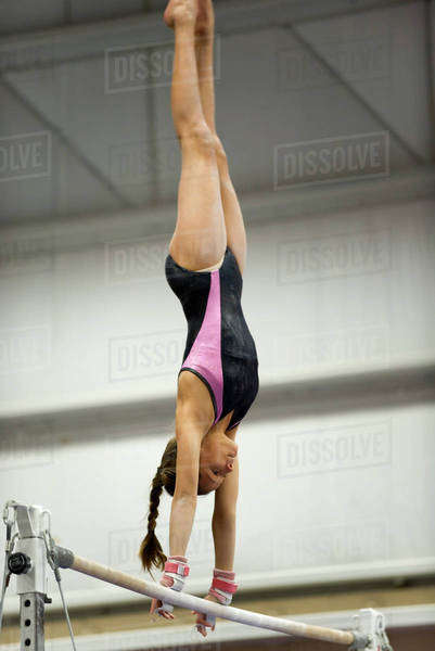 Gymnast doing handstand with legs split - Stock Photo - Dissolve