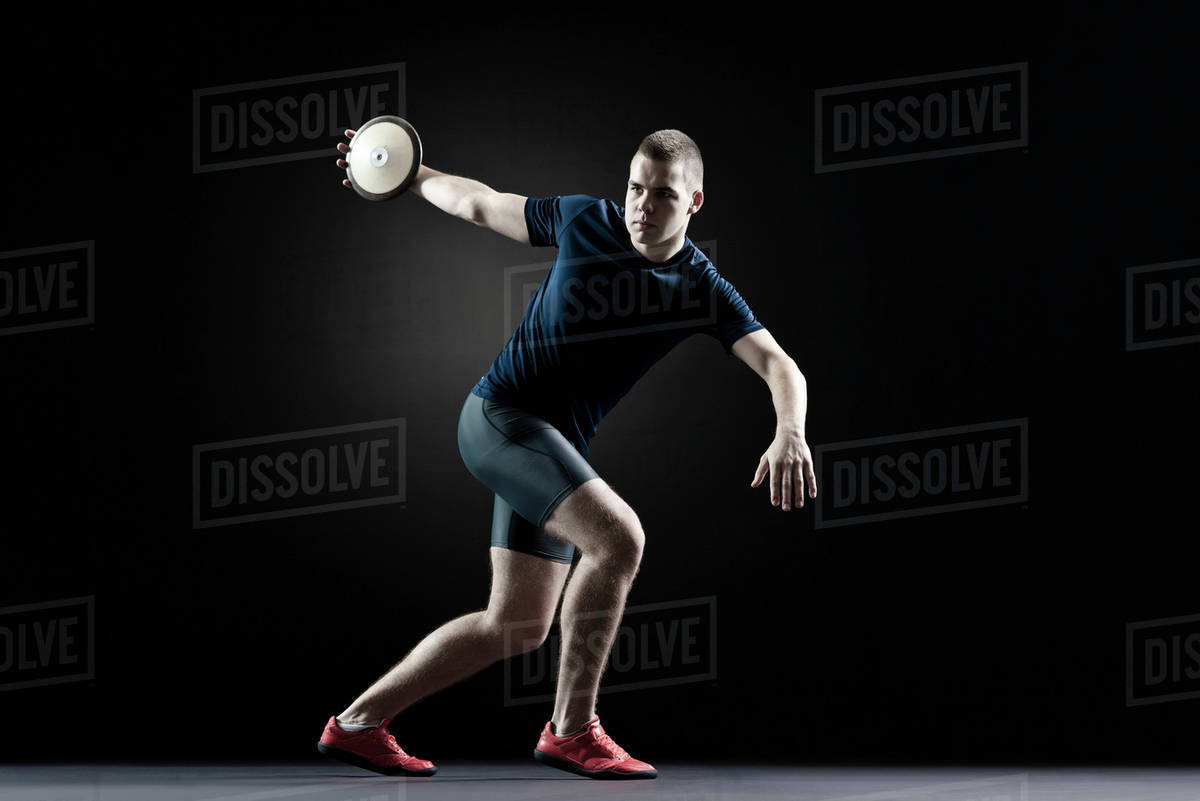 Male athlete throwing discus - Royalty-free Stock Photo | Dissolve
