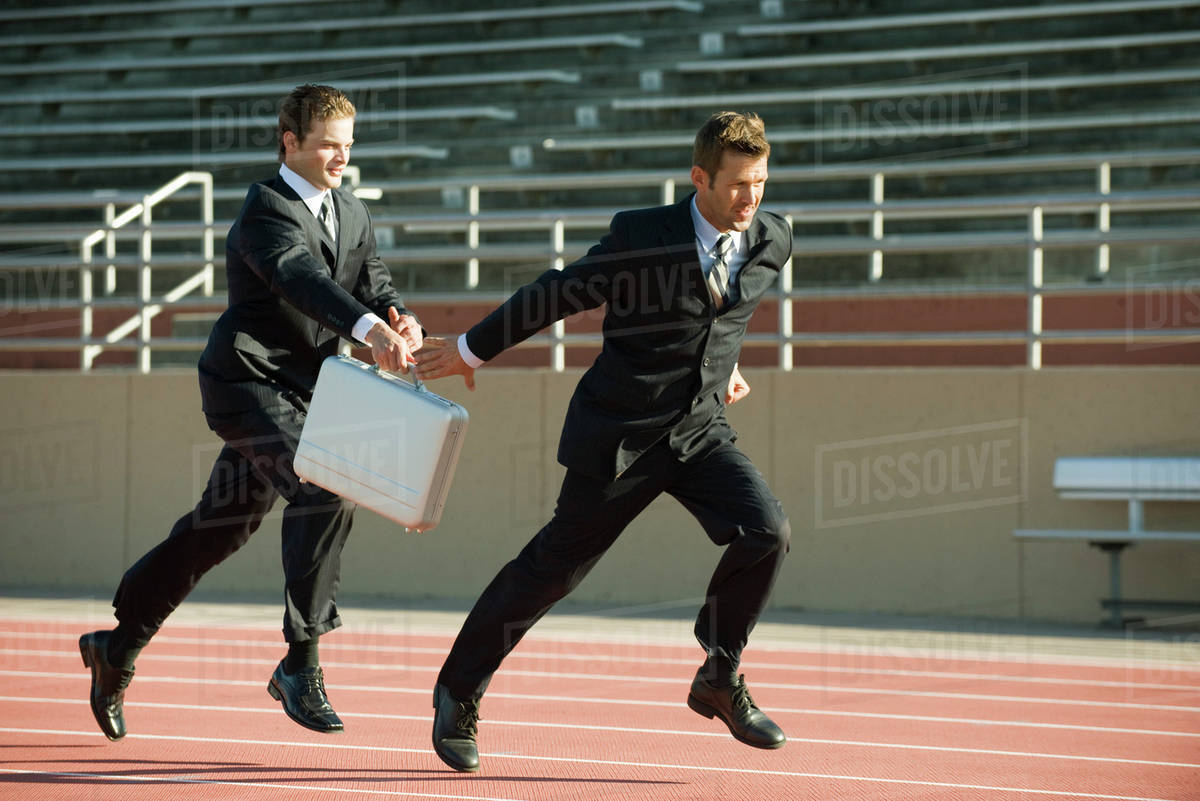 Businessmen running in relay race, handing off briefcase - Royalty-free ...