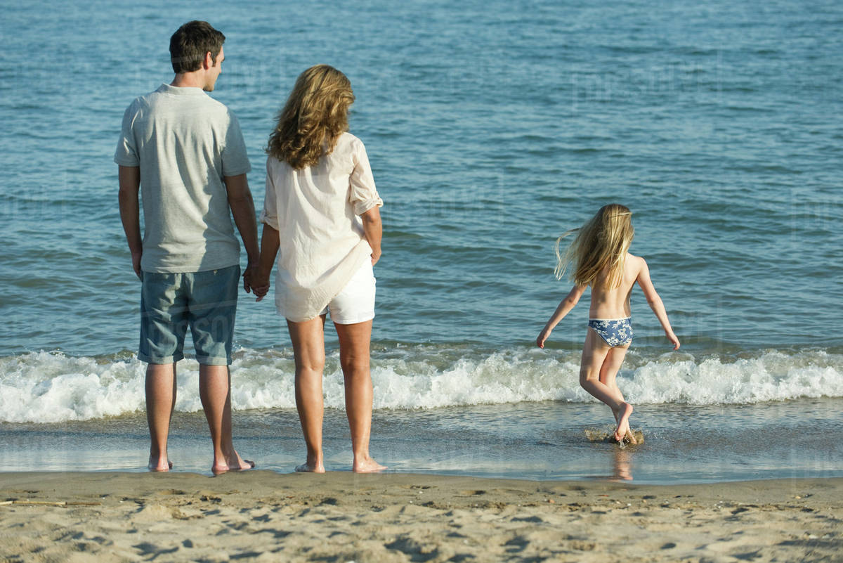 Family at the beach, rear view - Royalty-free Stock Photo | Dissolve