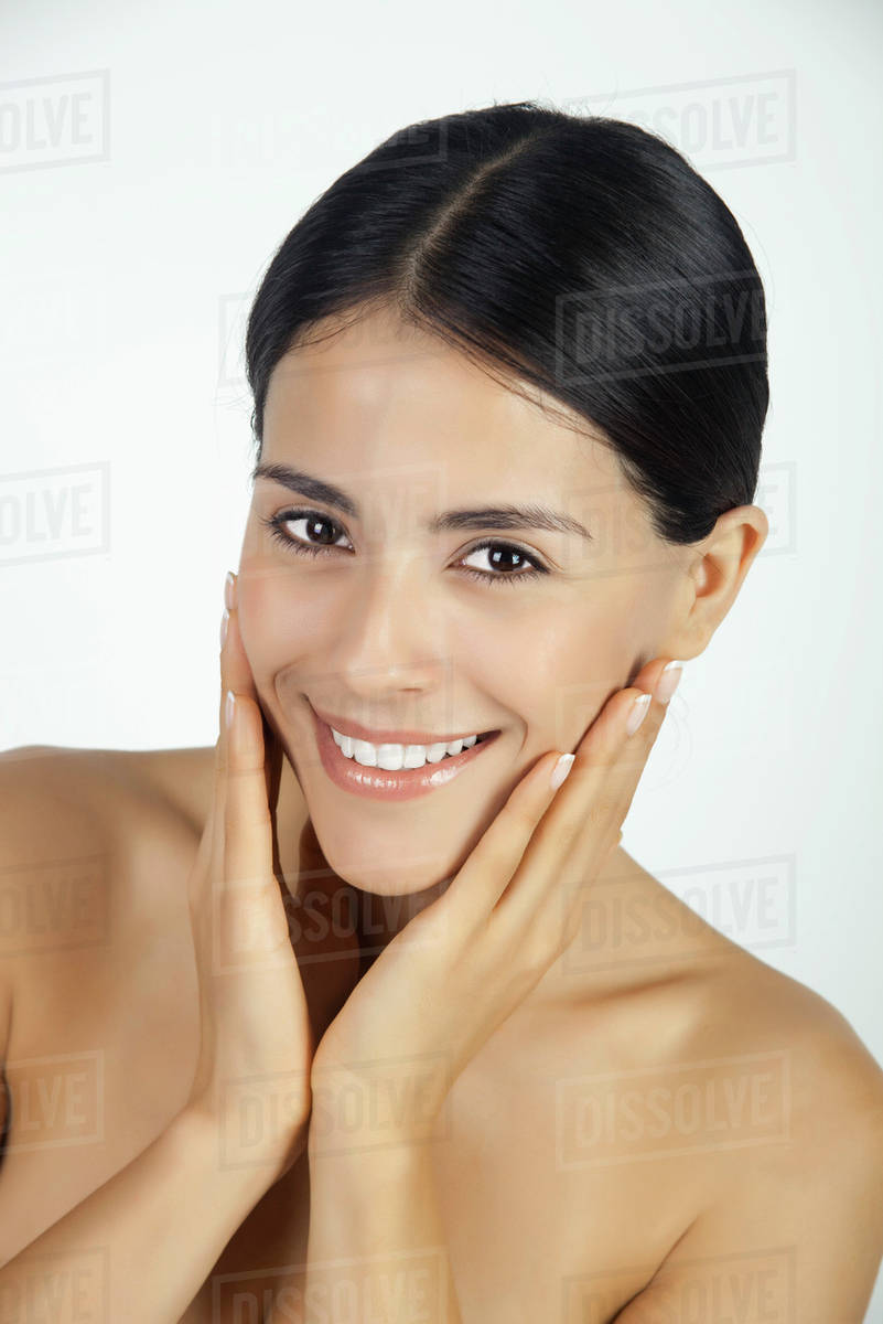 Woman with hands on cheeks, portrait - Royalty-free Stock Photo | Dissolve