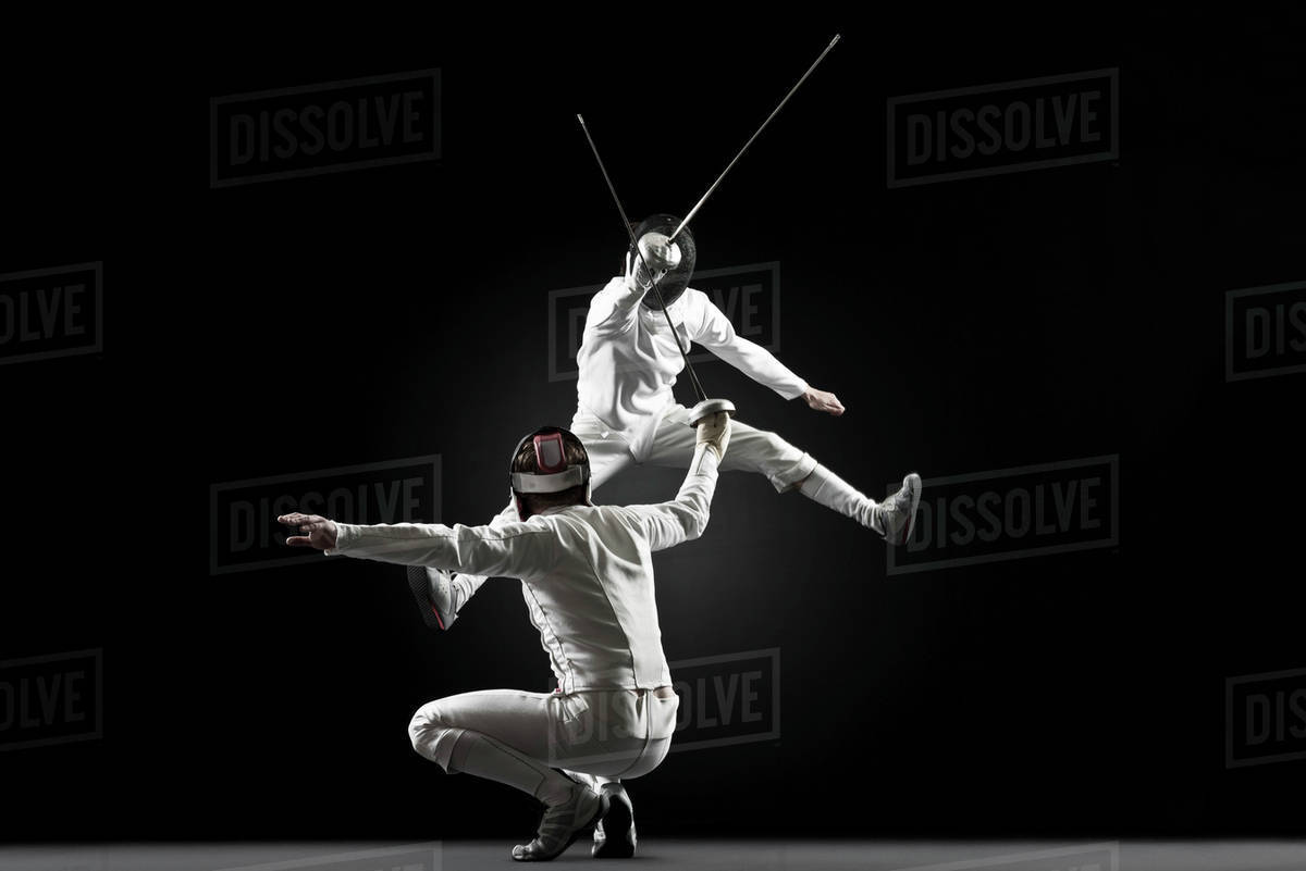 Fencers fencing, one fencer jumping in air - Royalty-free Stock Photo ...
