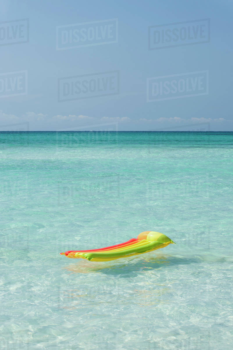 Pool raft floating in ocean - Stock Photo - Dissolve