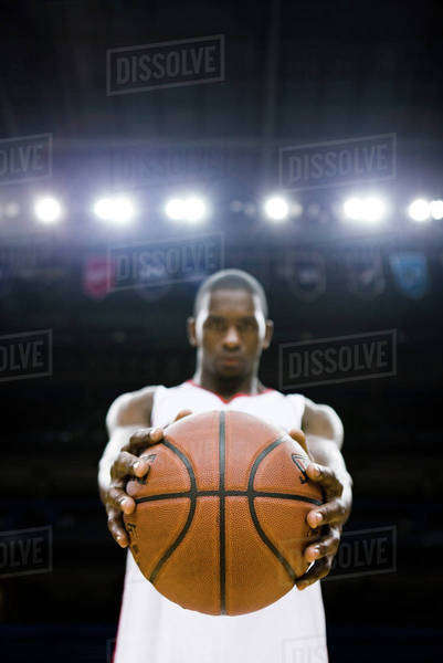 Basketball player holding basketball, focus on foreground - Royalty ...