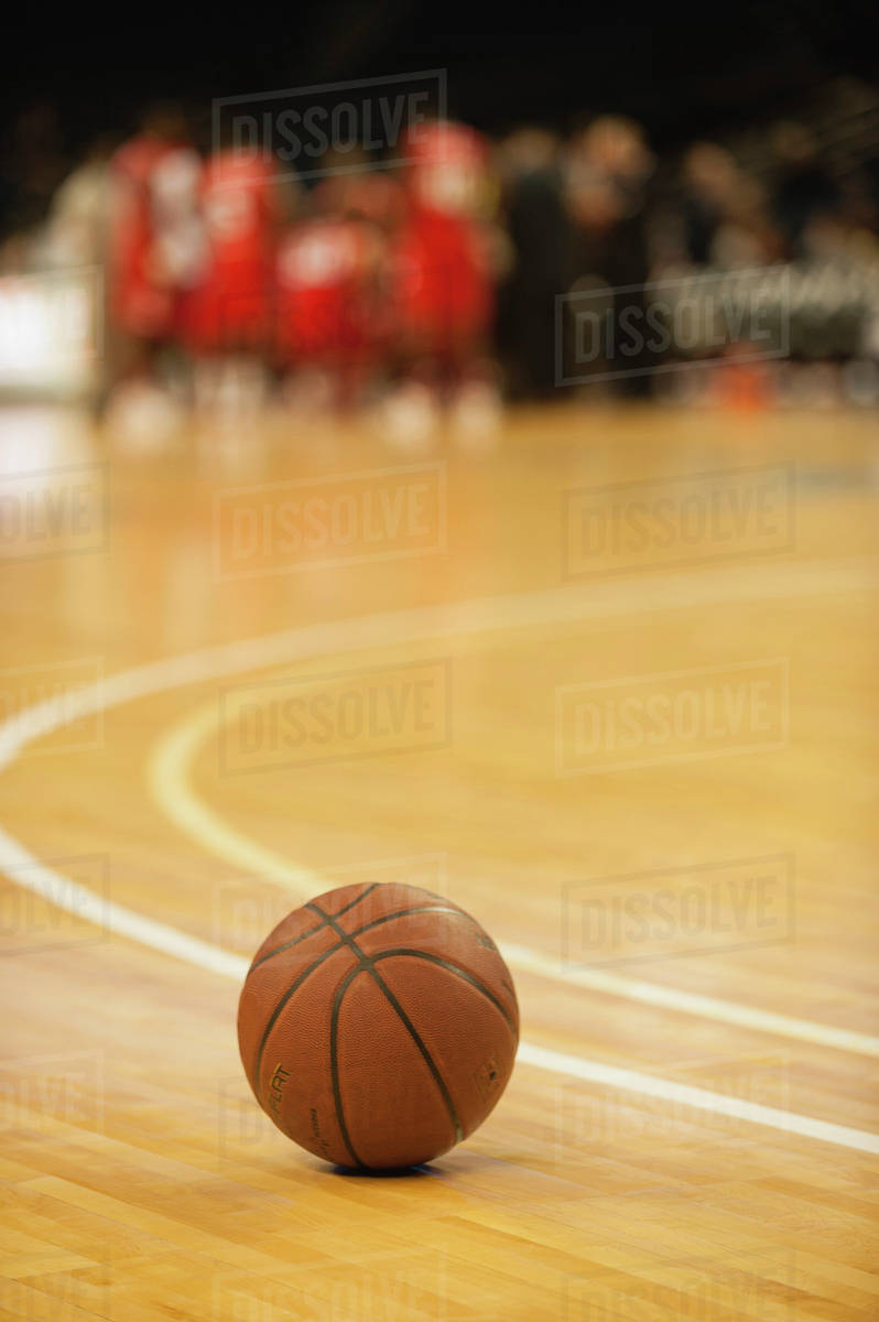 Basketball resting on court - Stock Photo - Dissolve