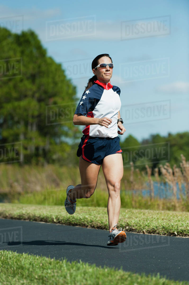 Woman running, portrait - Stock Photo - Dissolve