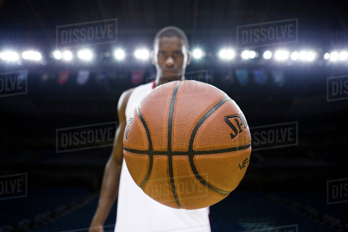 Basketball player holding basketball, focus on foreground - Royalty ...