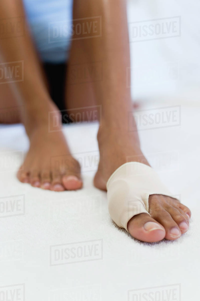 Woman's foot wrapped in brace for injured toe, low section - Royalty ...