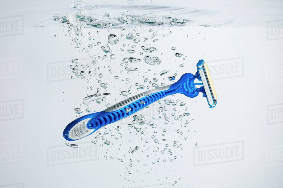 Disposable razor submerged in water - Royalty-free Stock Photo | Dissolve