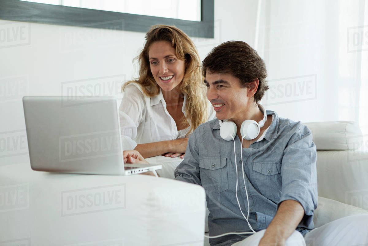 Couple looking at laptop computer - Royalty-free Stock Photo | Dissolve