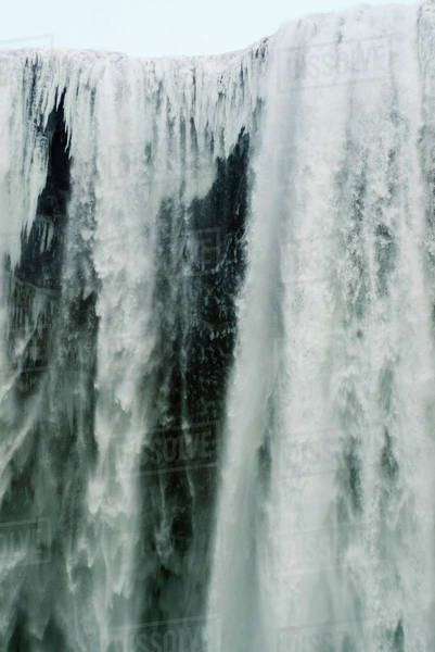 Frozen Skogafoss waterfall, Skogar, Iceland - Stock Photo - Dissolve