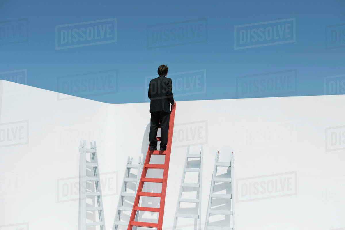 Businessman climbing ladder, rear view - Royalty-free Stock Photo ...