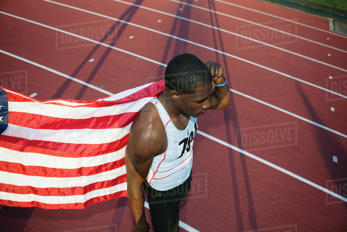 Runner holding up American flag after race - Royalty-free Stock Photo ...