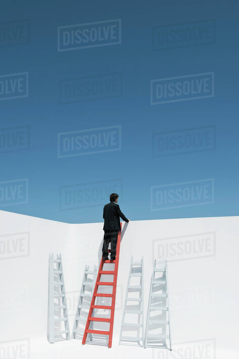 Businessman climbing ladder, rear view - Royalty-free Stock Photo ...