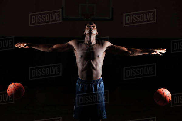 Barechested basketball player dribbling two basketballs - Royalty-free ...