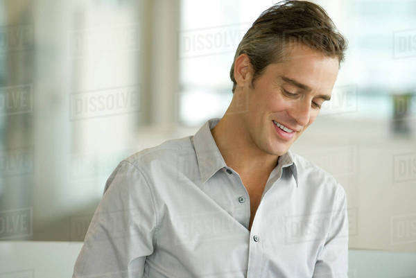 Man looking down and smiling, portrait - Royalty-free Stock Photo ...