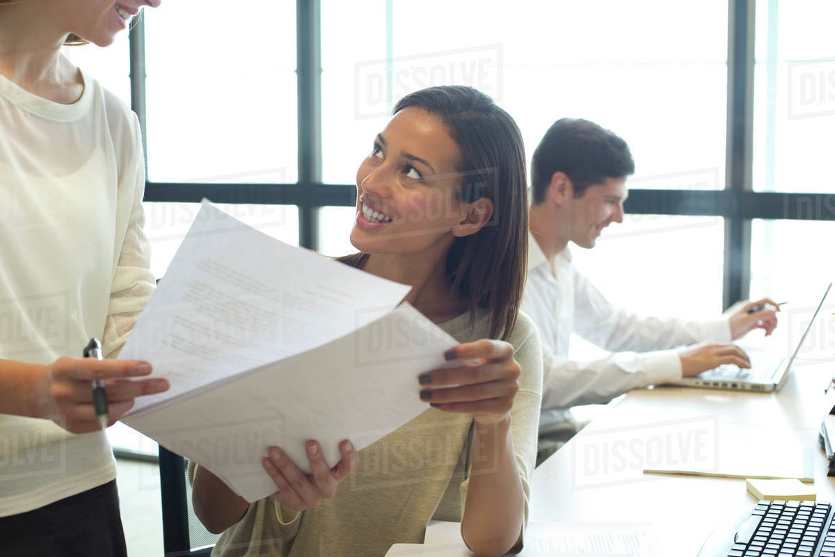 Colleagues reviewing documents together - Royalty-free Stock Photo ...
