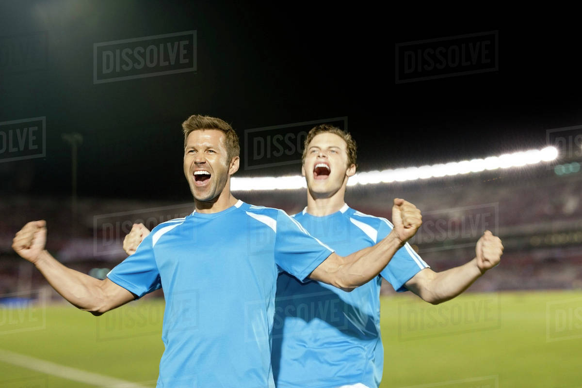 Soccer players celebrating, portrait - Royalty-free Stock Photo | Dissolve
