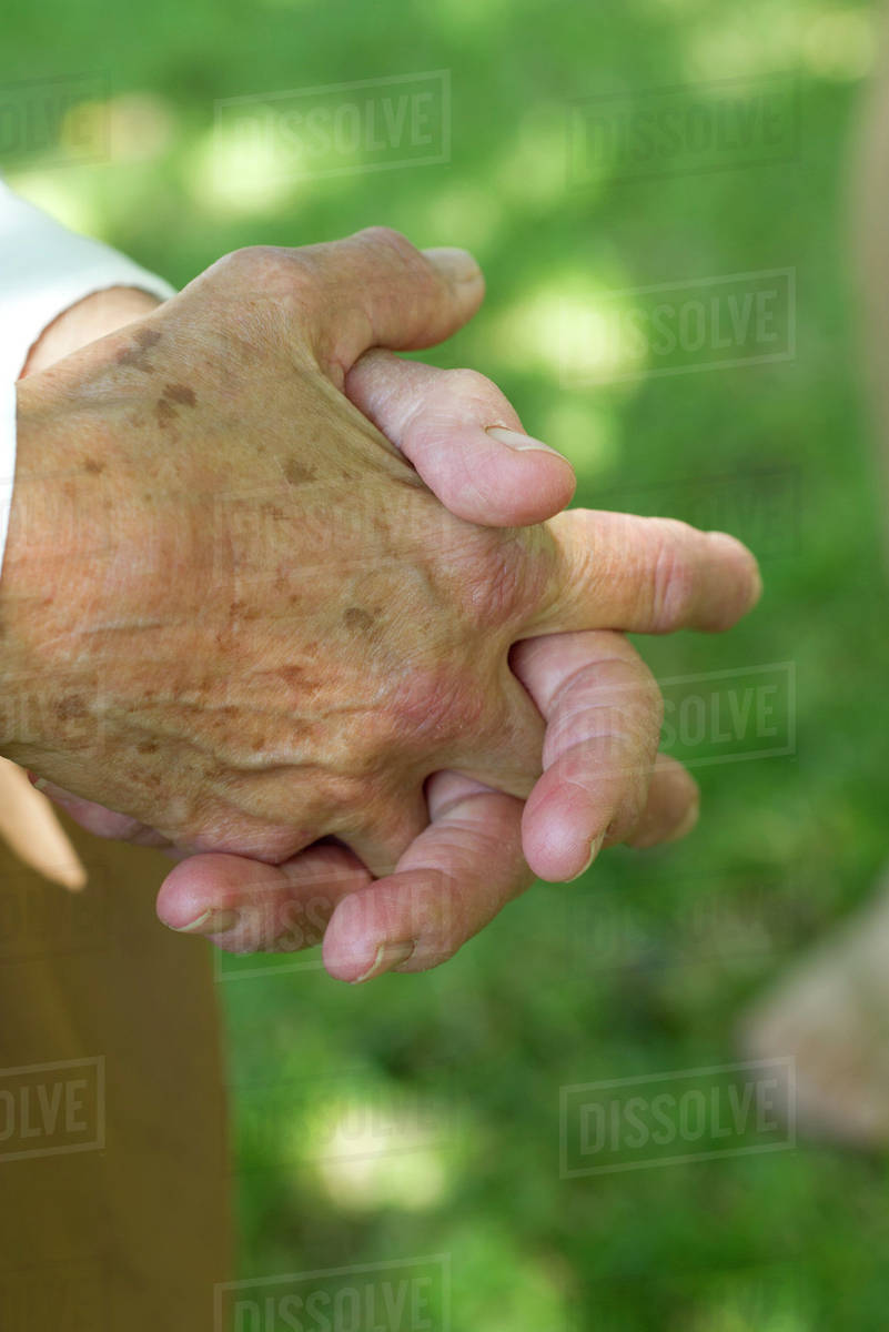 Elderly person's clasped hands - Royalty-free Stock Photo | Dissolve