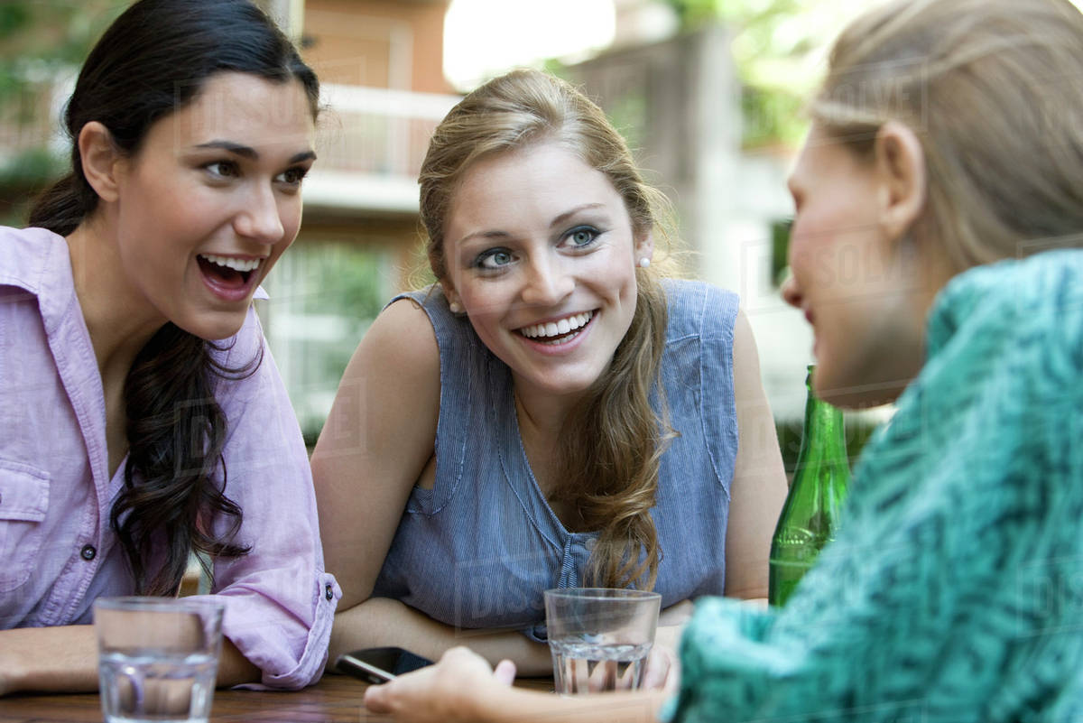 Friends chatting together - Royalty-free Stock Photo | Dissolve