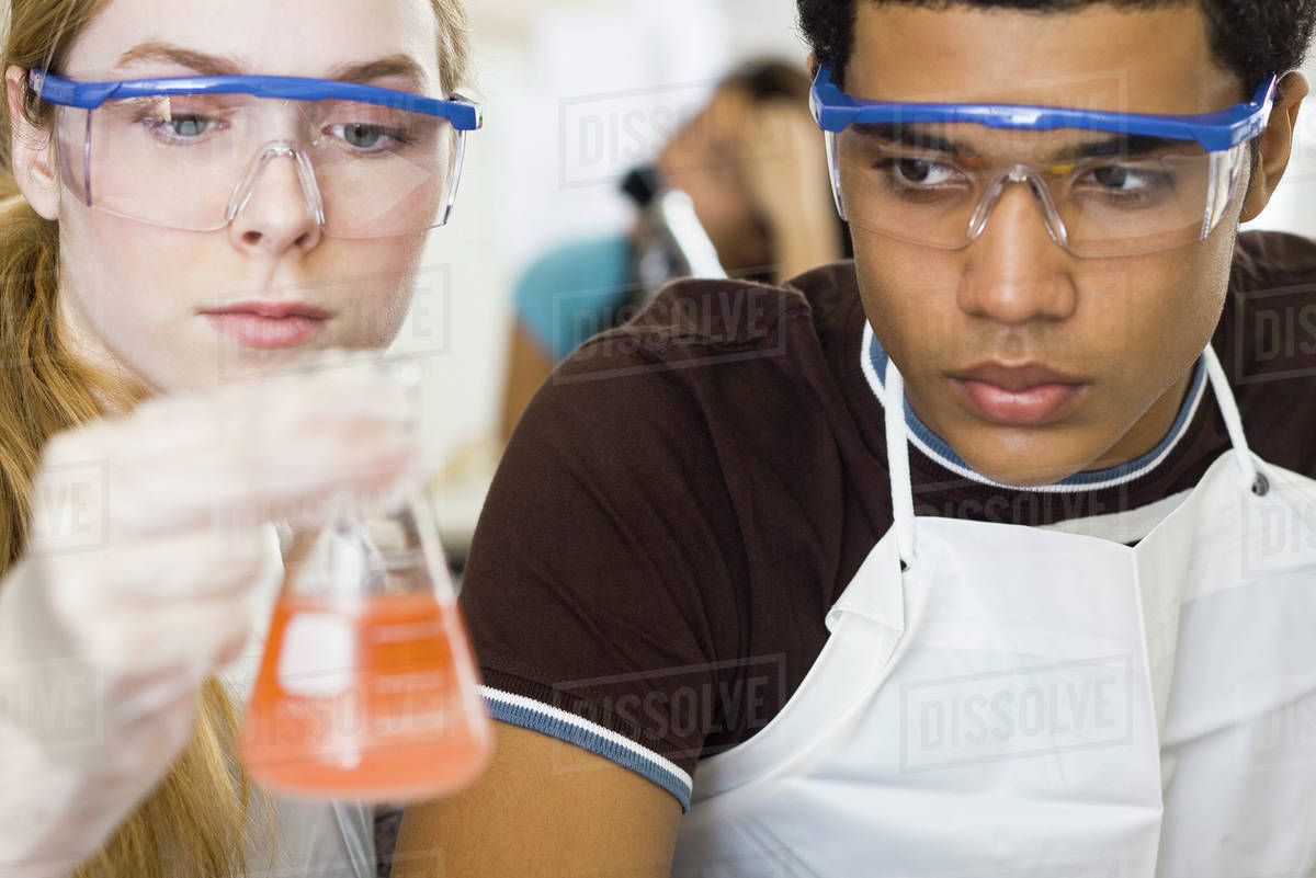 High school students conducting experiment in chemistry class - Royalty ...