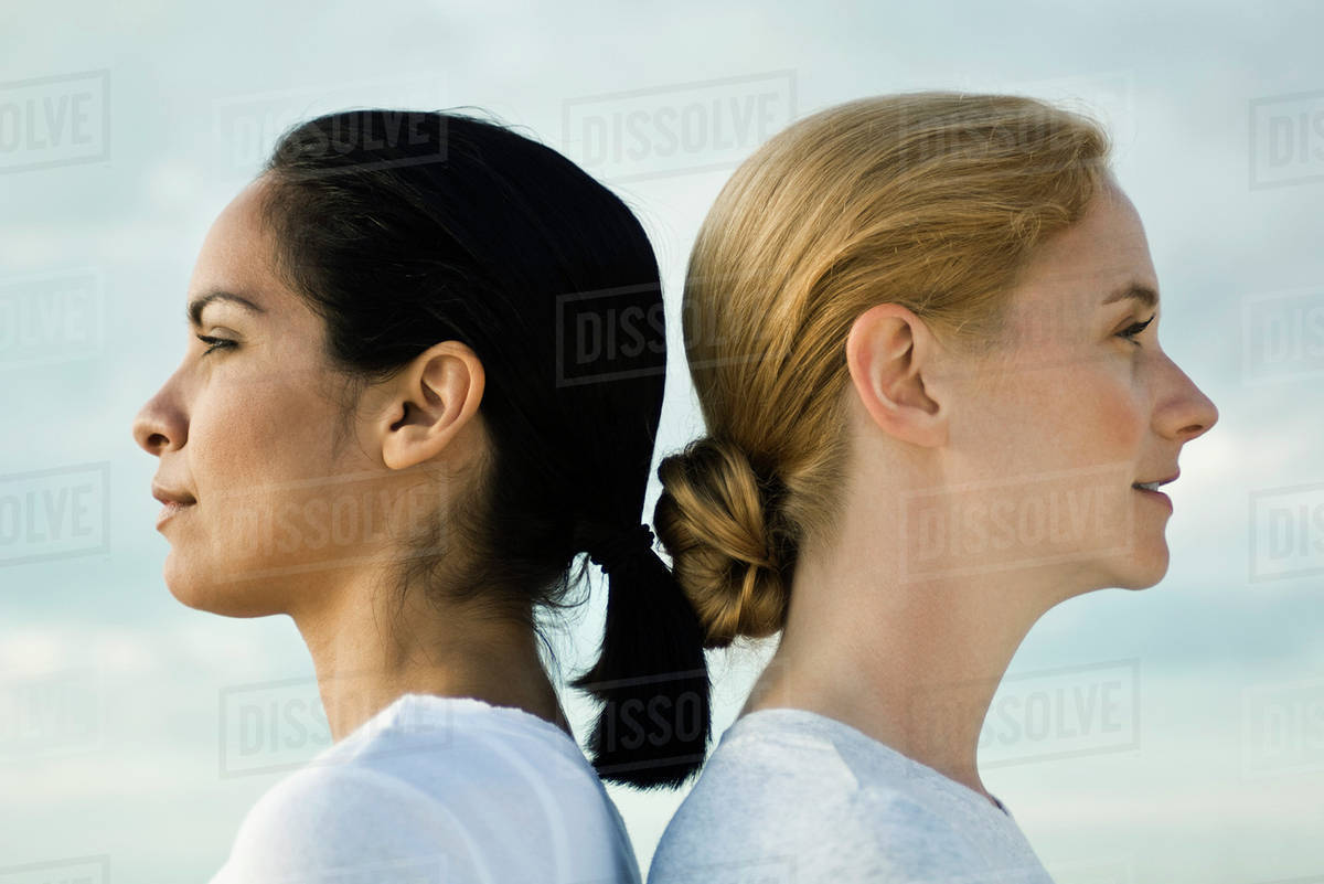 Women back to back, portrait - Stock Photo - Dissolve