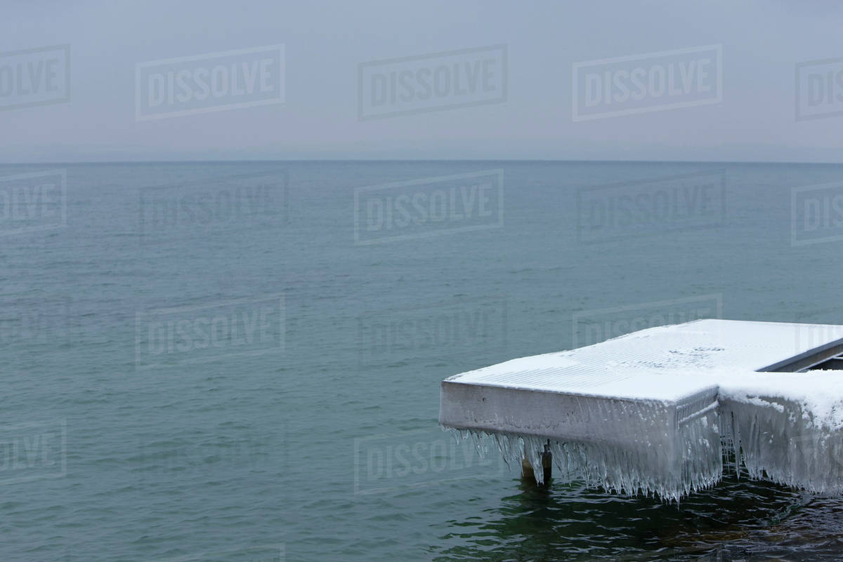 Dock covered in ice and snow - Stock Photo - Dissolve