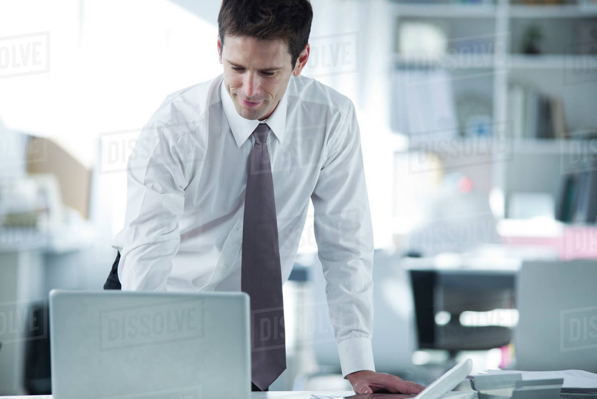 Businessman using laptop computer in office - Royalty-free Stock Photo ...