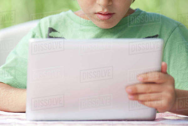 Boy using digital tablet - Royalty-free Stock Photo | Dissolve
