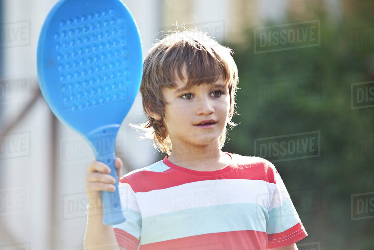 Boy holding racket - Stock Photo - Dissolve