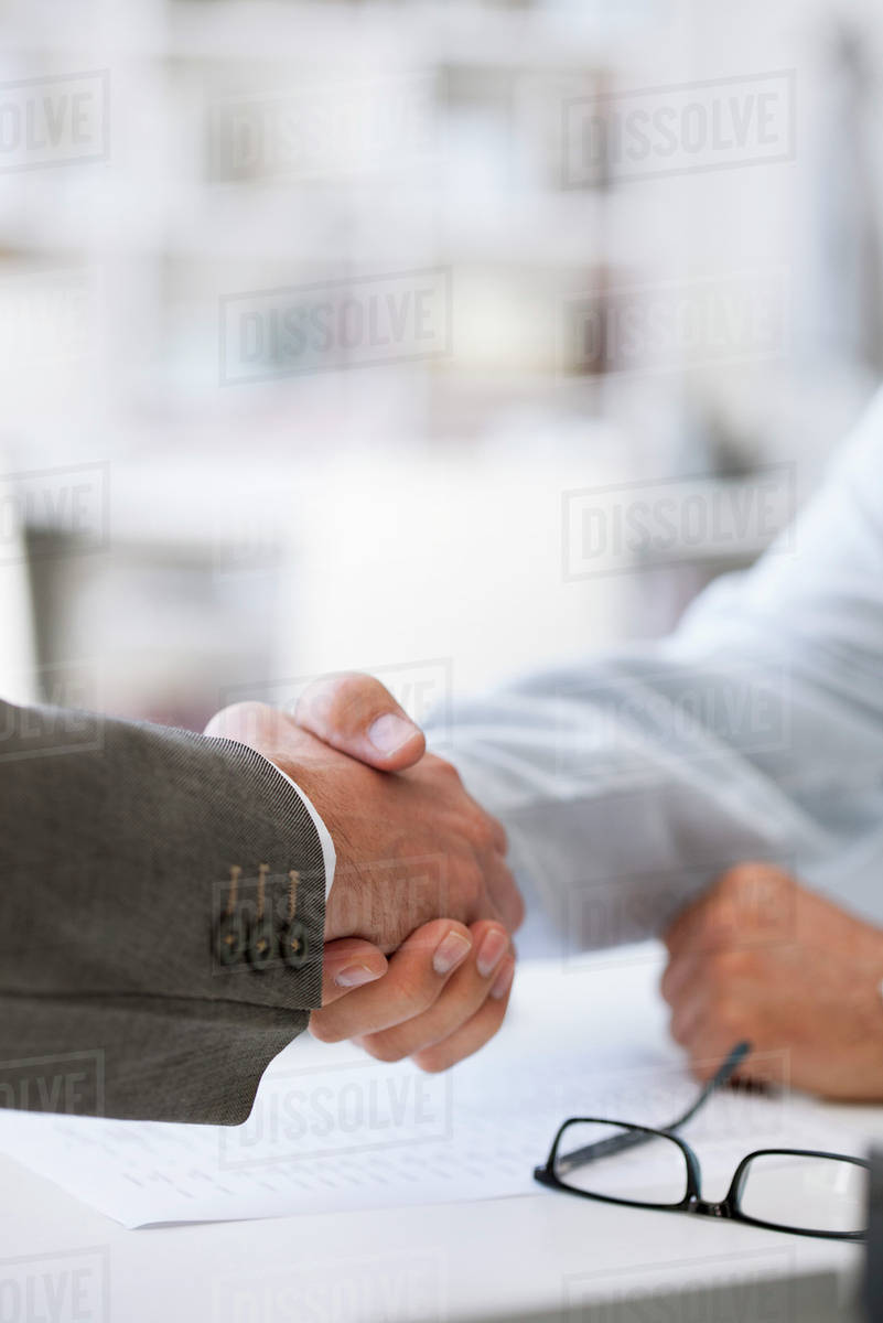 Business deal closed with handshake - Royalty-free Stock Photo | Dissolve