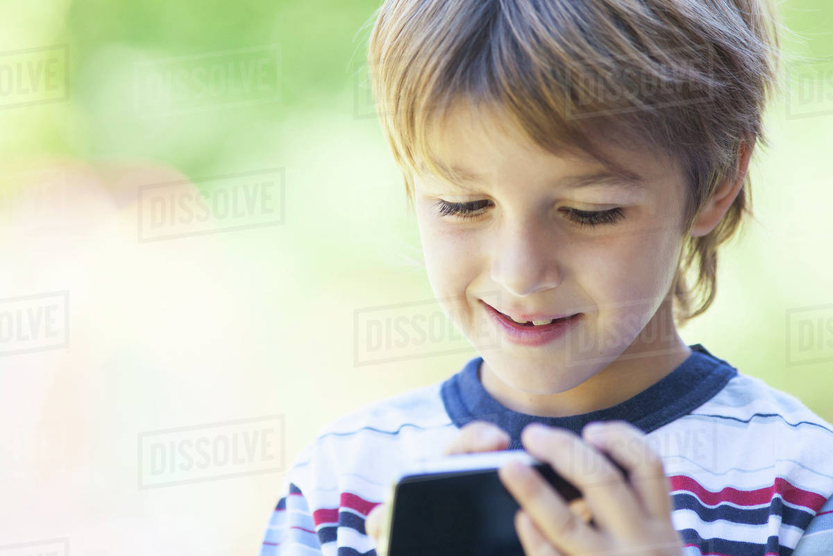 Boy using smartphone - Royalty-free Stock Photo | Dissolve