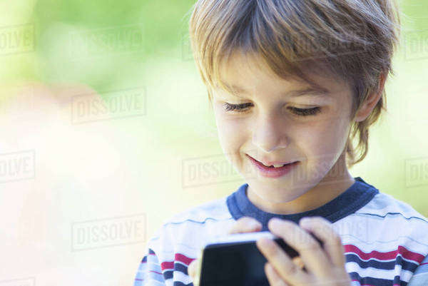 Boy using smartphone - Royalty-free Stock Photo | Dissolve