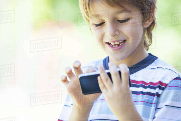 Boy using smartphone - Royalty-free Stock Photo | Dissolve