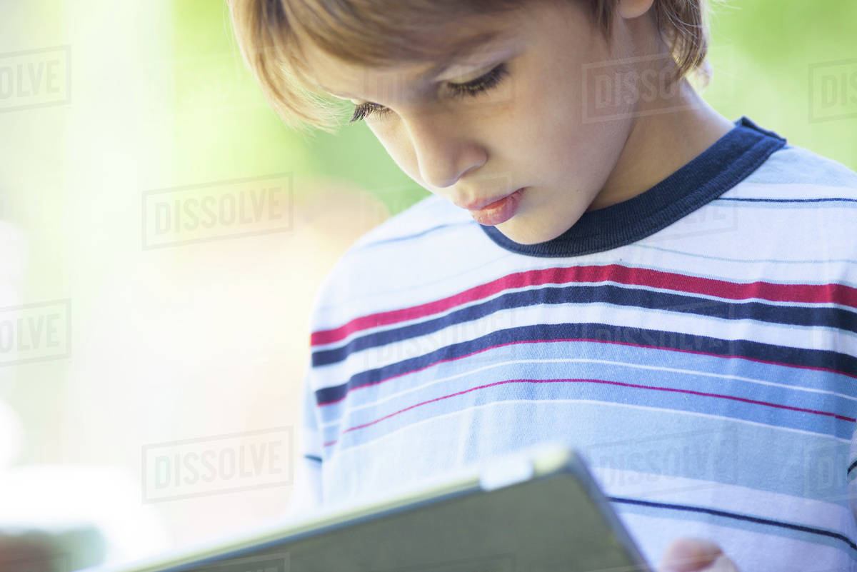 Boy using digital tablet - Royalty-free Stock Photo | Dissolve