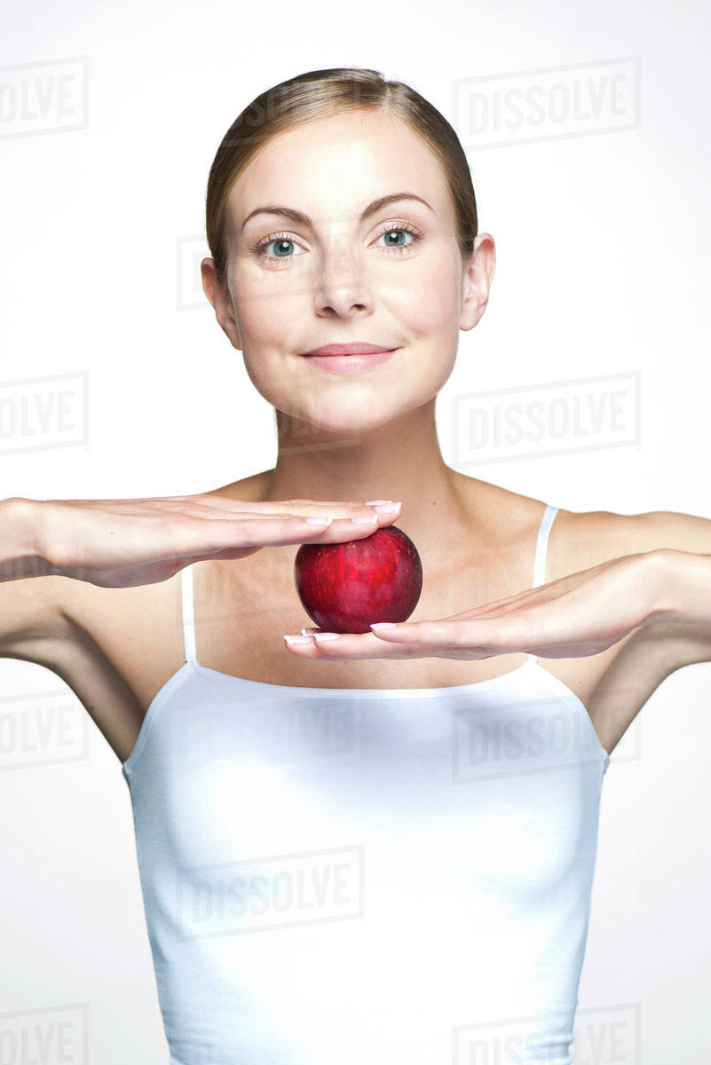Young woman with apple - Stock Photo - Dissolve