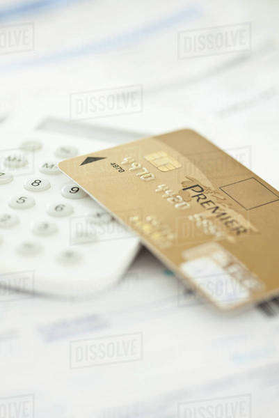 Credit card resting on calculator - Royalty-free Stock Photo | Dissolve
