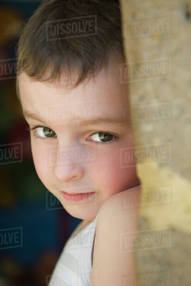 Little boy leaning against tree trunk, portrait - Royalty-free Stock ...