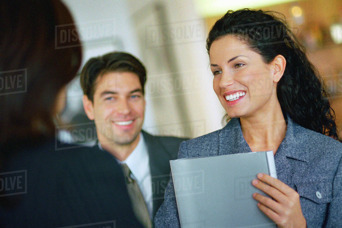 Female associate meeting with colleagues - Stock Photo - Dissolve