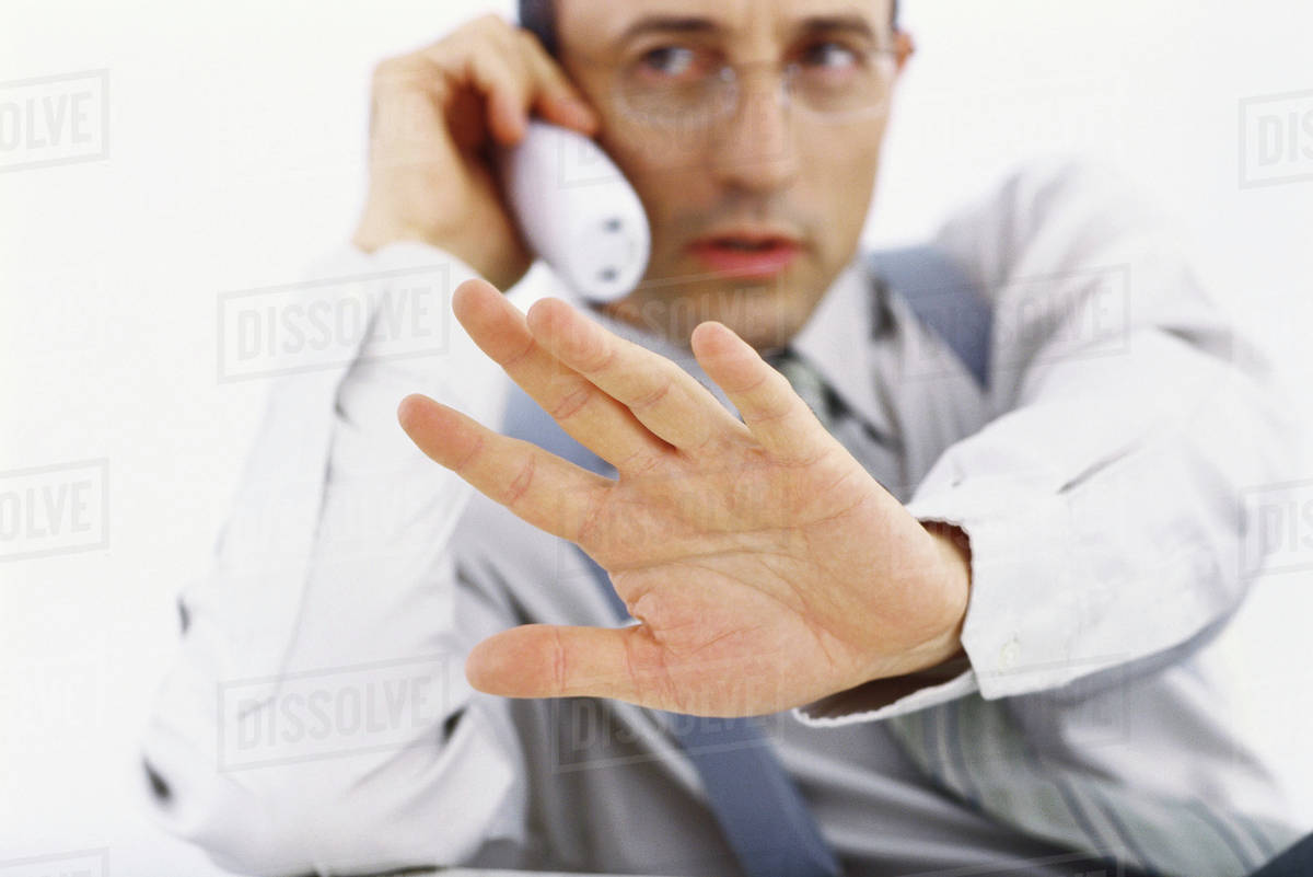 Businessman on phone call making stop gesture with hand - Royalty-free ...