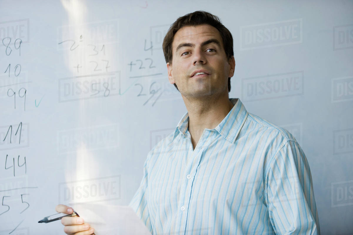 Math teacher in front of whiteboard, looking expectantly - Stock Photo ...