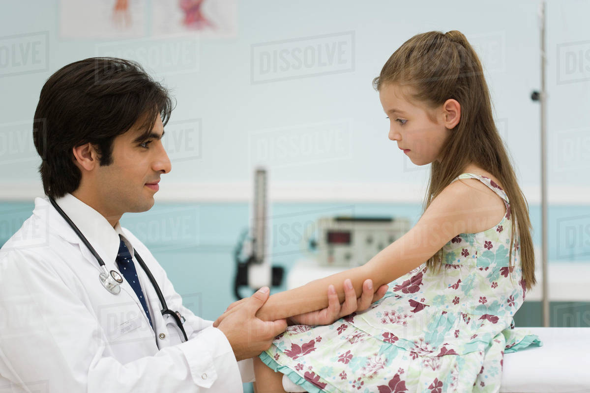 Pediatrician examining little girl's arm - Royalty-free Stock Photo ...