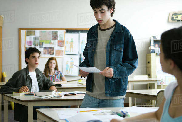 High school student giving presentation in class - Stock Photo - Dissolve