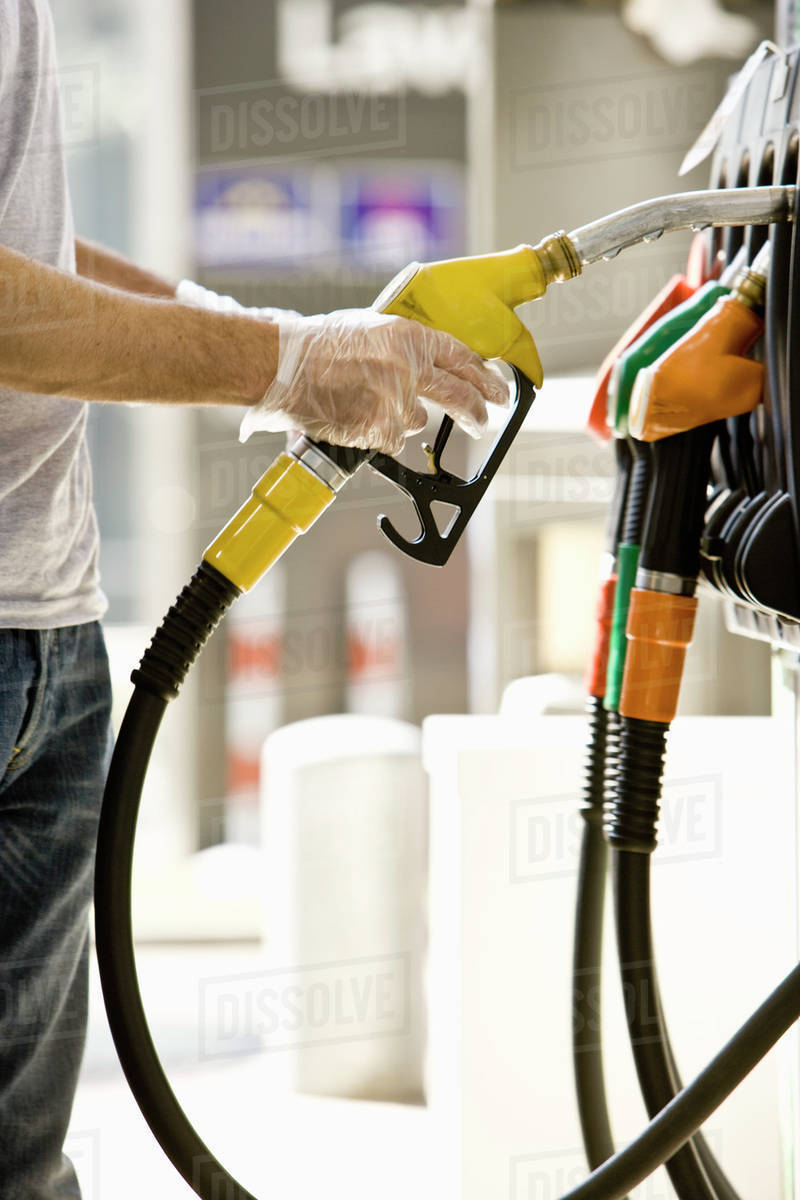 Man at gas pump preparing to refuel vehicle - Royalty-free Stock Photo ...