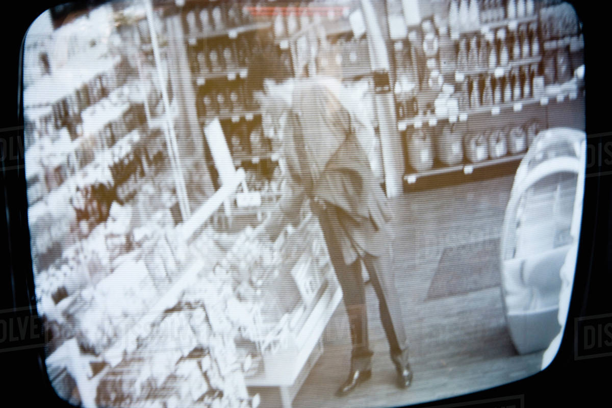 Customer browsing in convenience store, image captured by surveillance ...