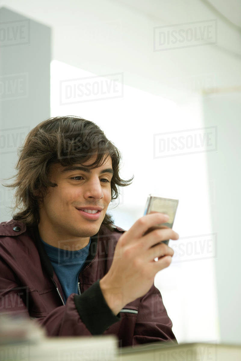 Young man text messaging - Royalty-free Stock Photo | Dissolve