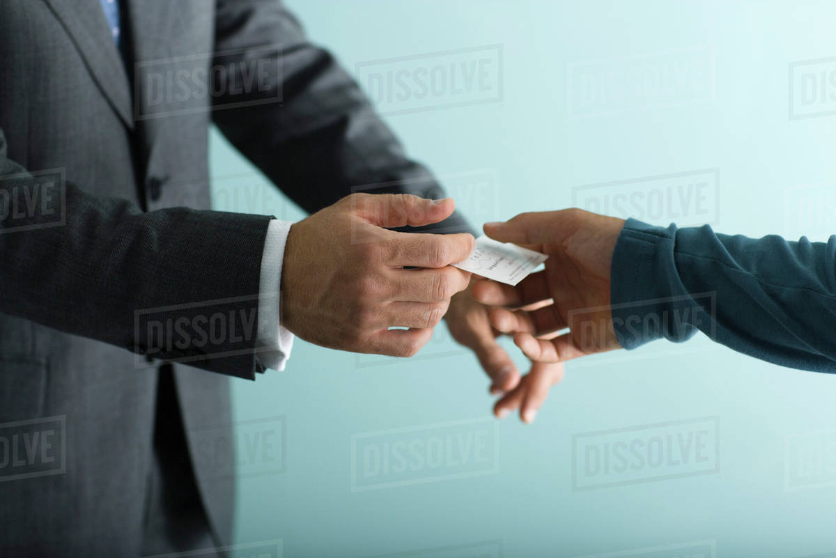 Businessman handing business card to client - Royalty-free Stock Photo ...