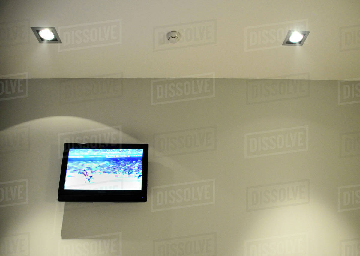 Flat screen television mounted on wall - Stock Photo - Dissolve