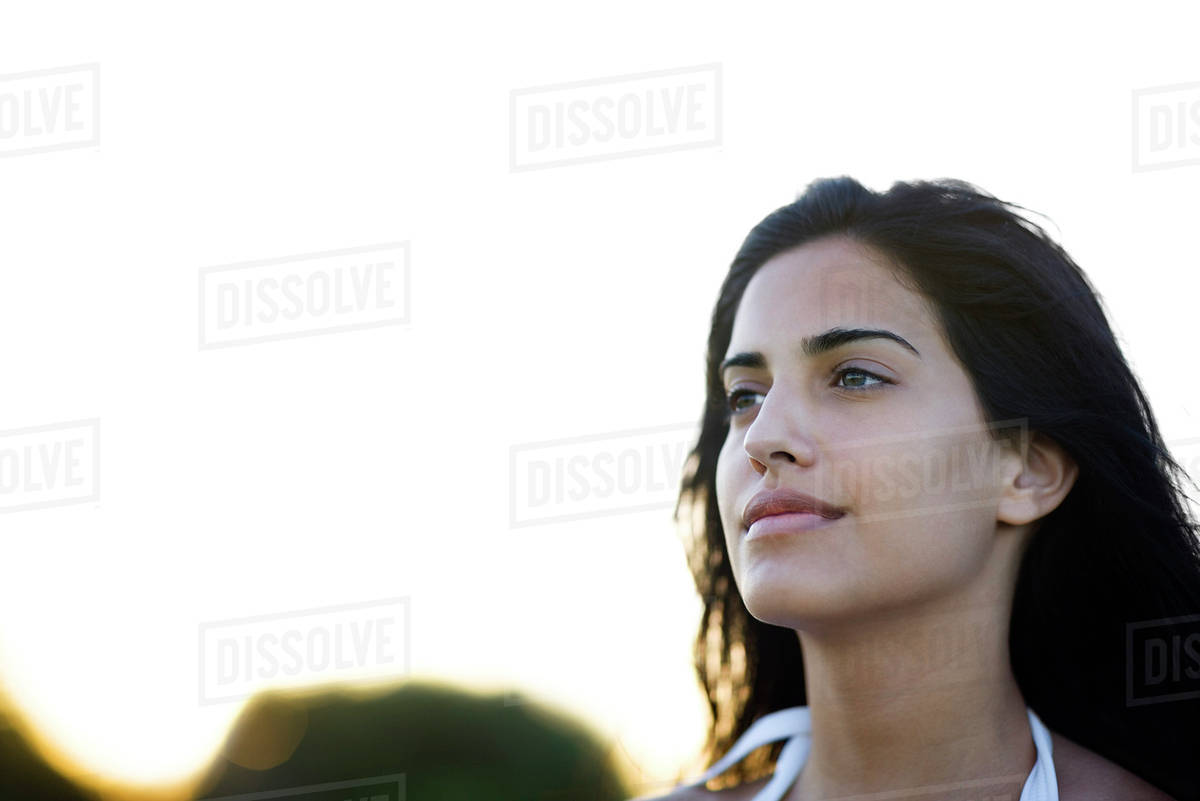 Young woman looking away contentedly, portrait - Stock Photo - Dissolve